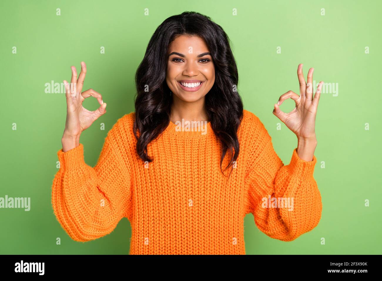 Photo of charming cute dark skin woman wear orange sweater showing two ...