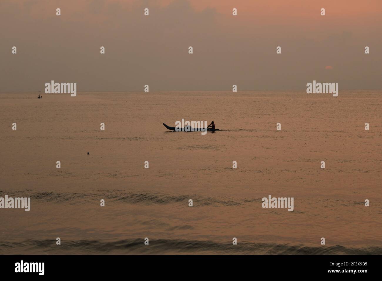Picture of a man on a boat alone at sea Stock Photo - Alamy