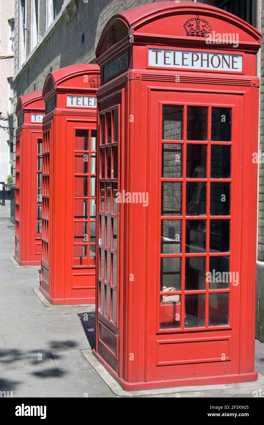 Three of the famous British red telephone boxes containing coin ...