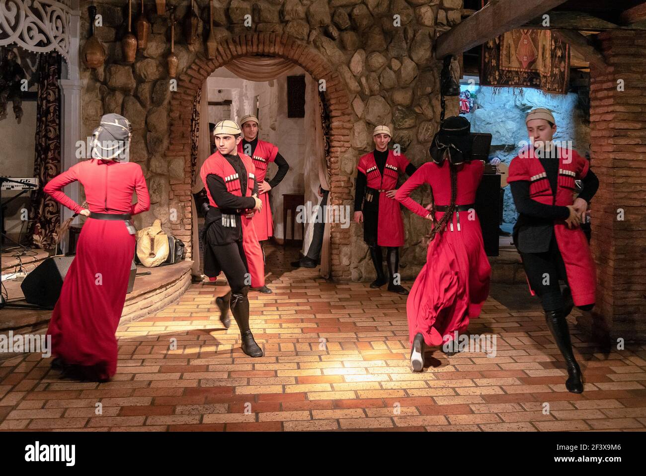 Georgian dancers dancing a folklore dance show on stage in Tbilisi ...