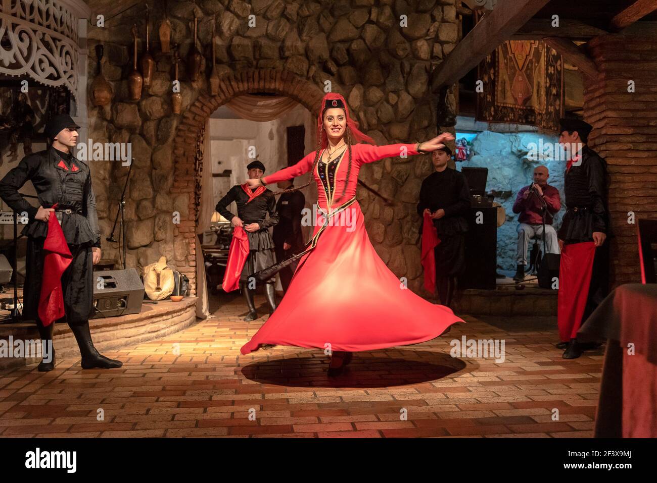 Georgian dancers dancing a folklore dance show on stage in Tbilisi ...