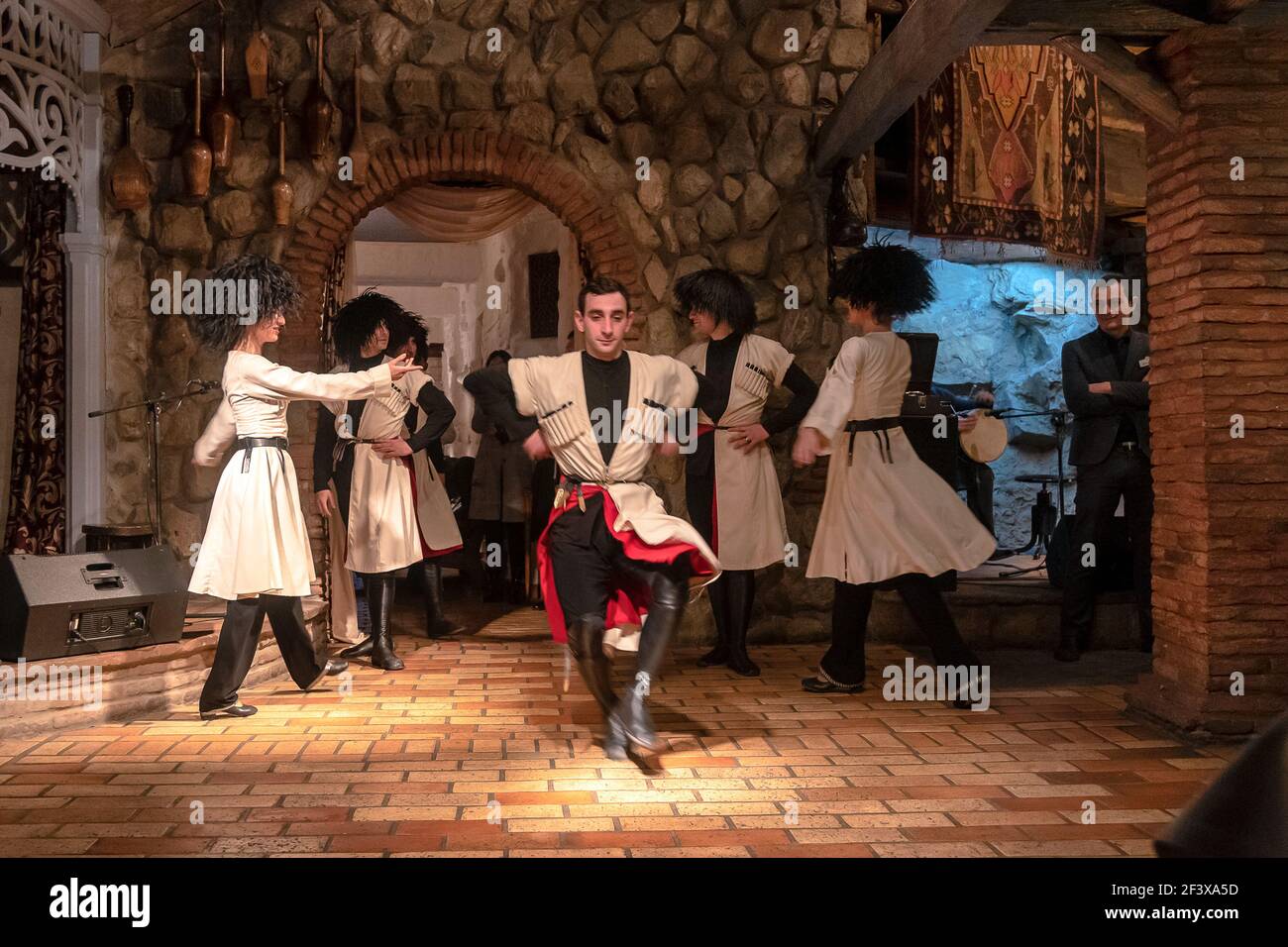 Georgian dancers dancing a folklore dance show on stage in Tbilisi ...
