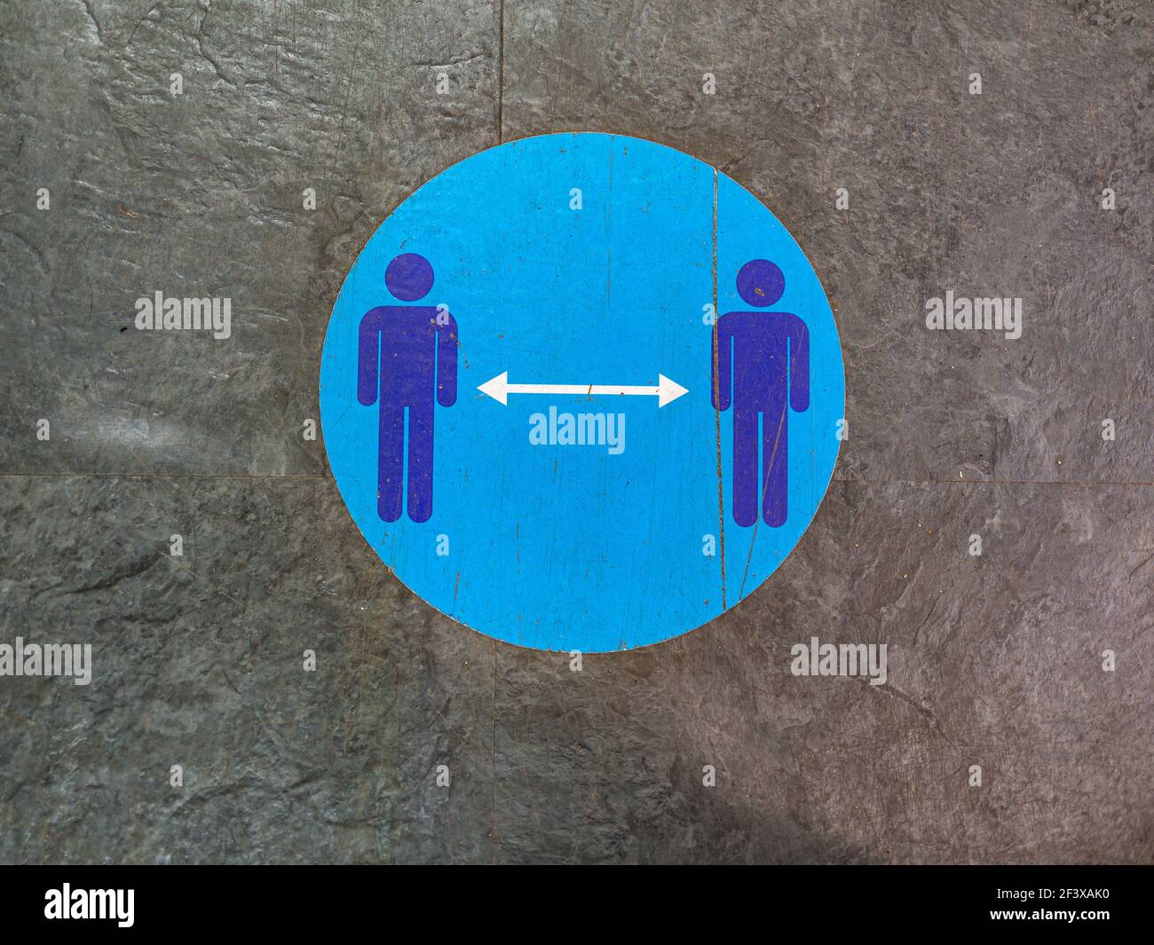 Floor sign in a store informing customers to keep to the 2m safe social ...