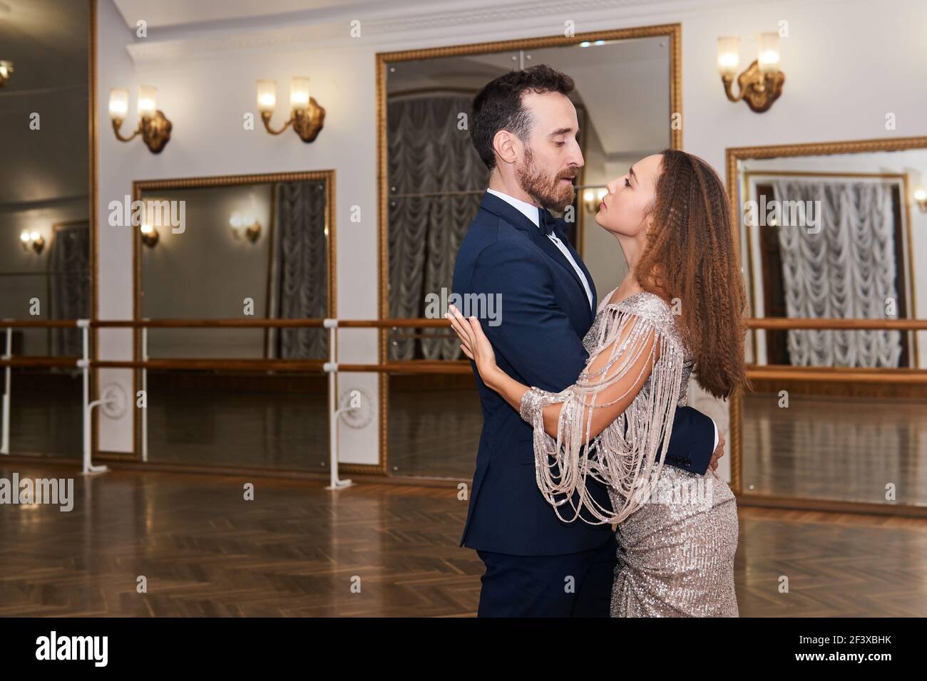 man and woman dancing classical partner dance in empty ballhall Stock ...