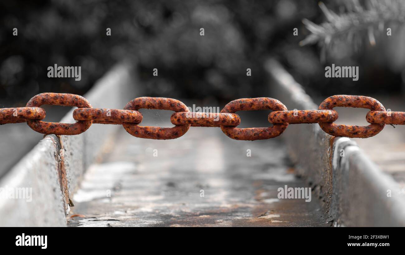 View of old rusty metal chain on roof Stock Photo - Alamy