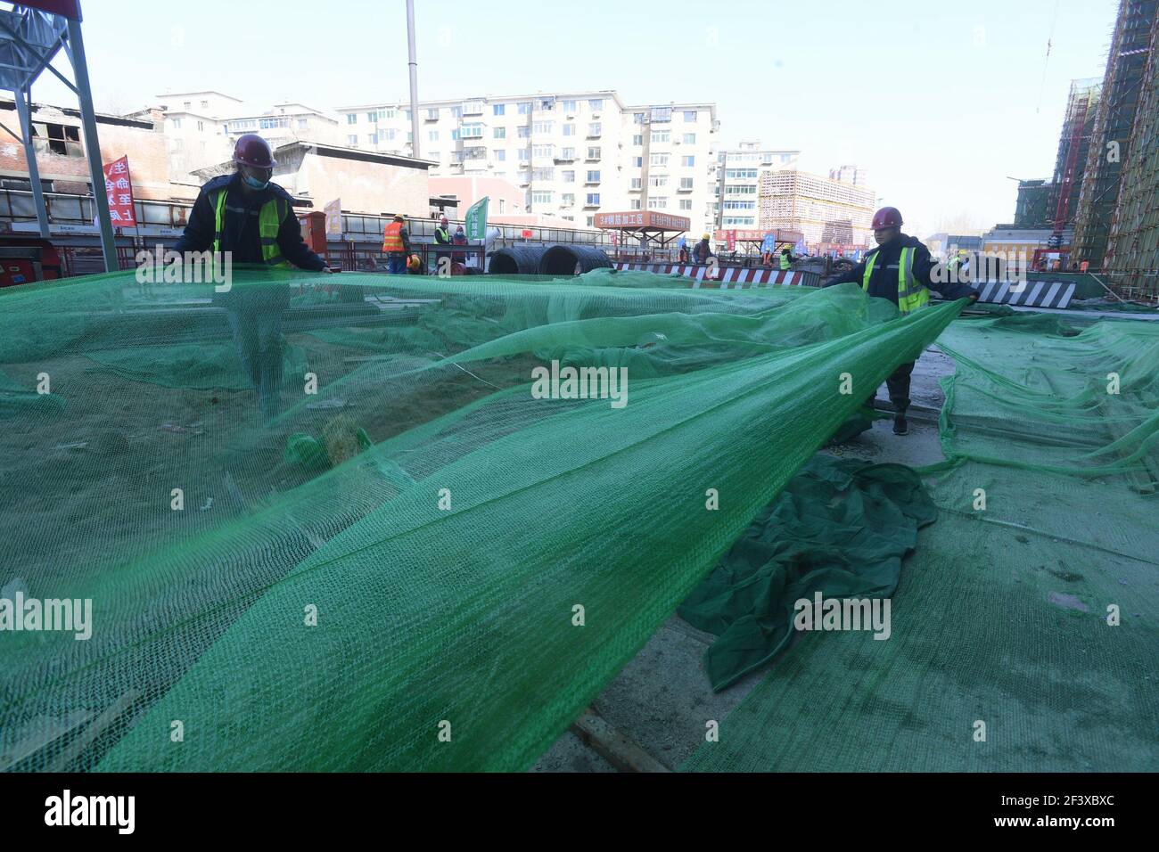 SHENYANG, CHINA - MARCH 16, 2021 - Workers work at a construction site ...