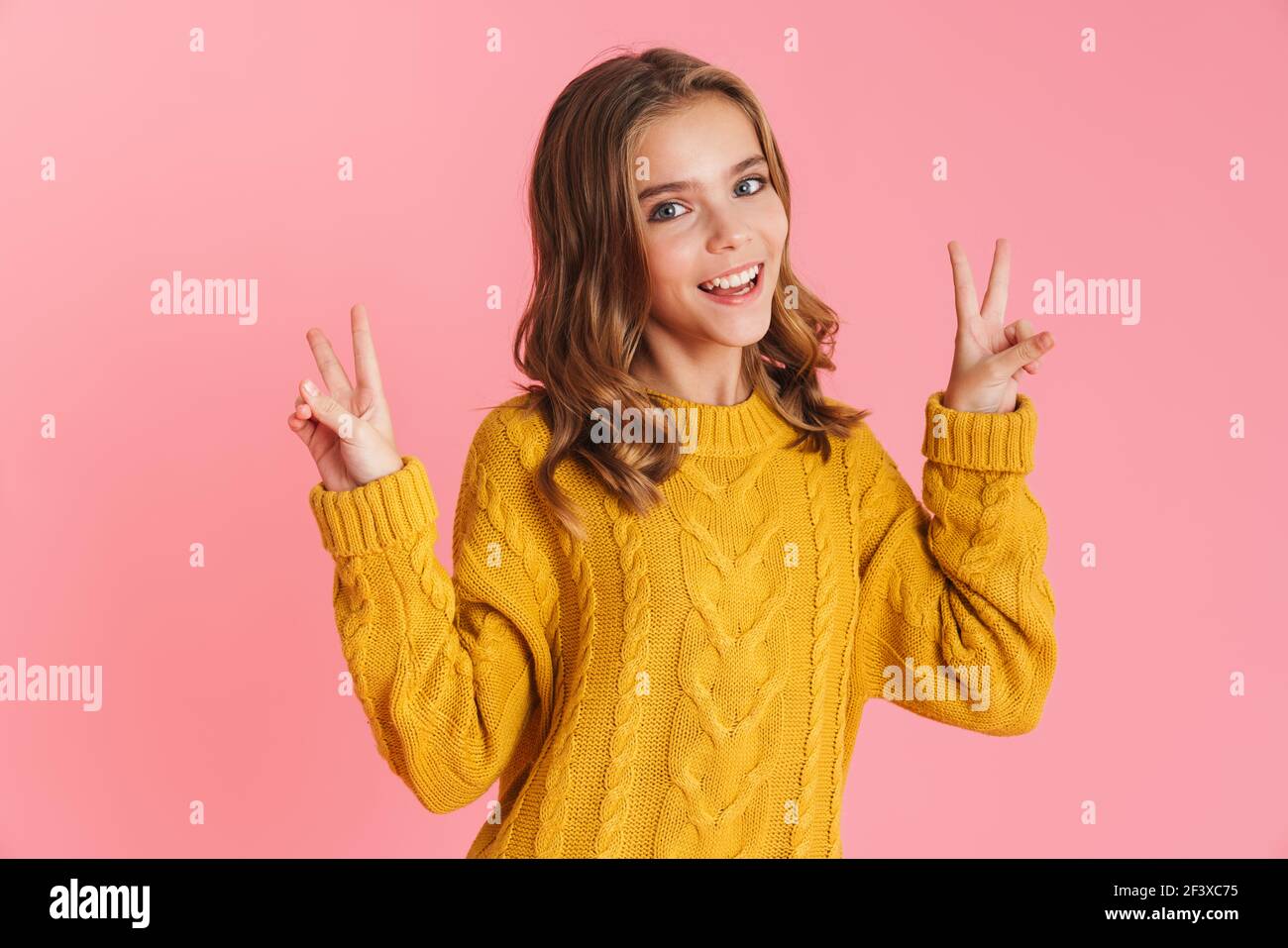 Happy beautiful blonde girl smiling and gesturing peace sign isolated ...