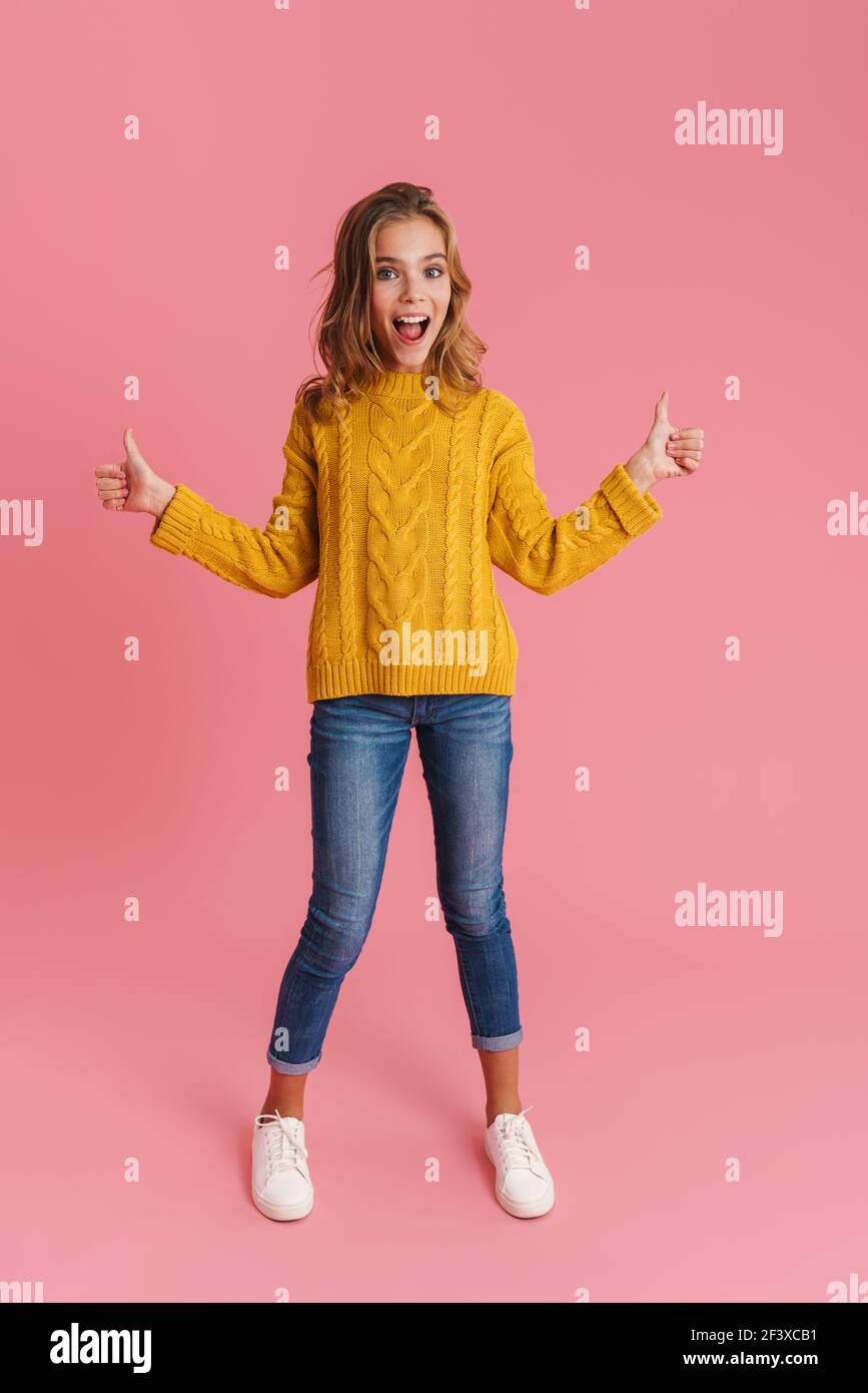 Excited beautiful blonde girl exclaiming and showing thumbs up isolated ...