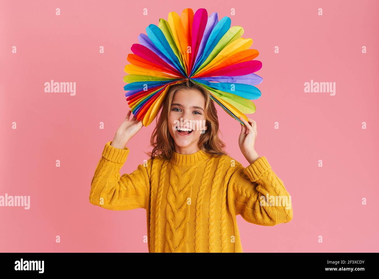 Joyful blonde girl laughing while posing with multicolored fan on her ...