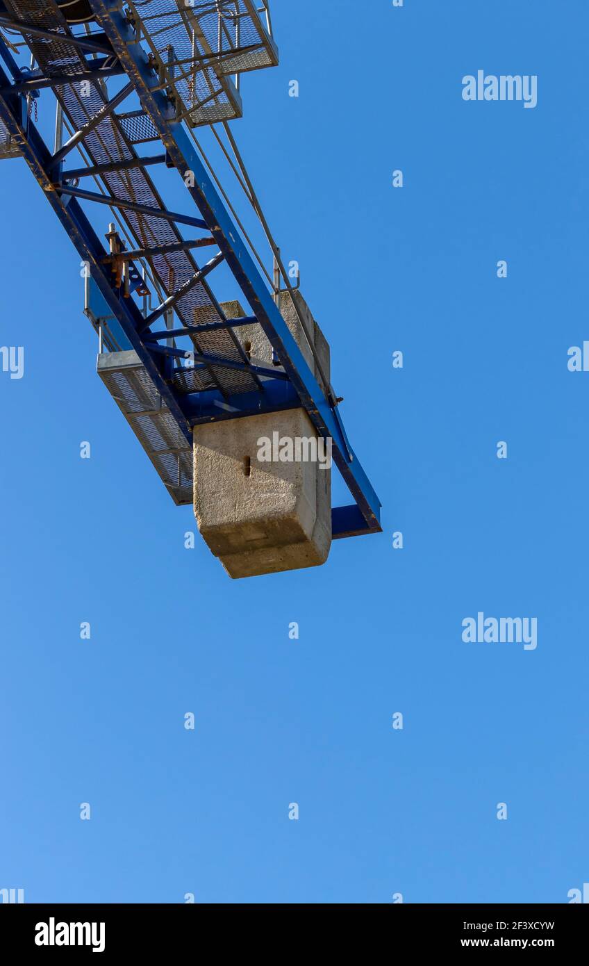 Concrete counterweights on tower crane to balance heavy load being ...