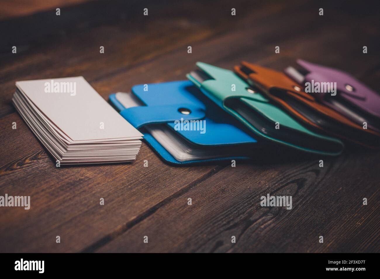 multicolored business card holders on a wooden background and a pack of ...
