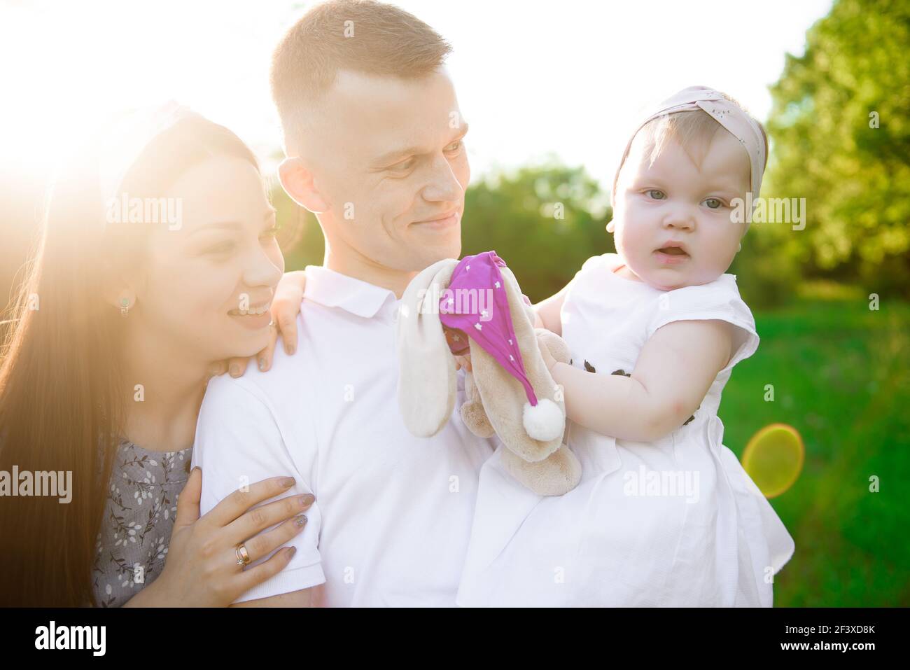 Happy family playing on the grass in the park in the evening Stock ...