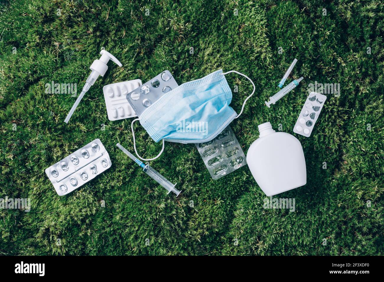 Used disposable medical face mask, latex medical gloves, drugs cover ...