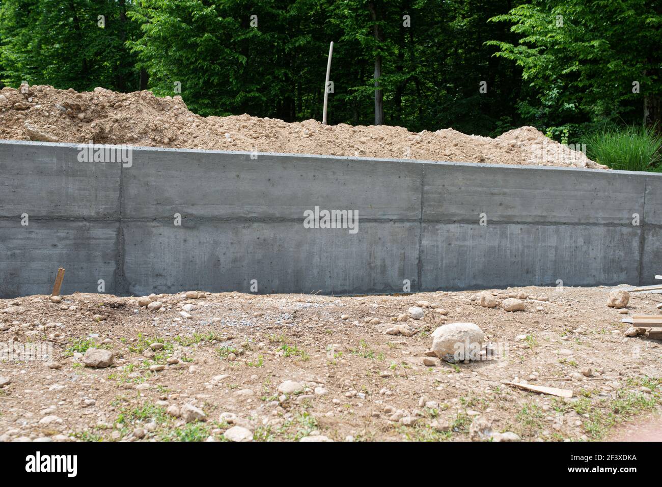 Concrete wall as a border between two pieces of land outside in a ...