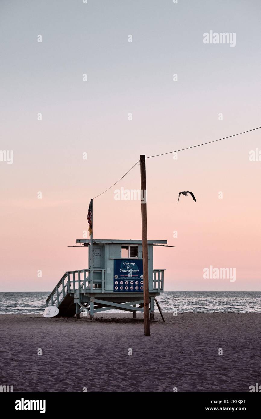 A vertical shot of a baywatch house on beautiful sunset background ...