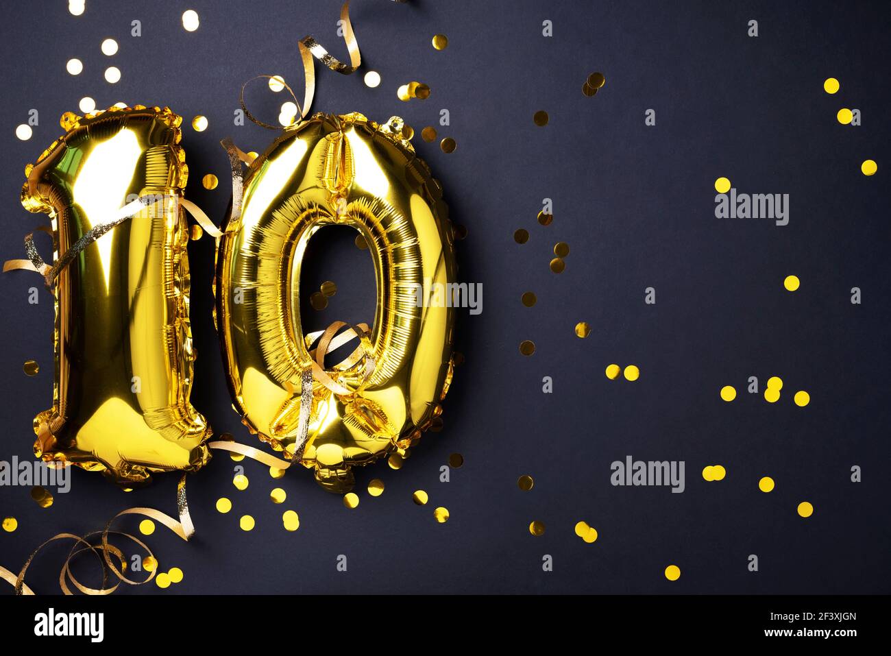 Gold foil balloon number, digit ten. Birthday greeting card with ...