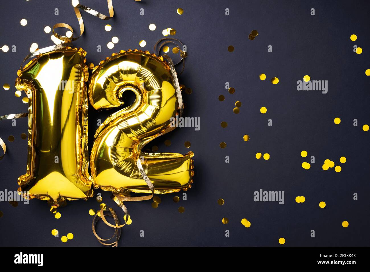 Gold foil balloon number, digit twelve. Birthday greeting card ...