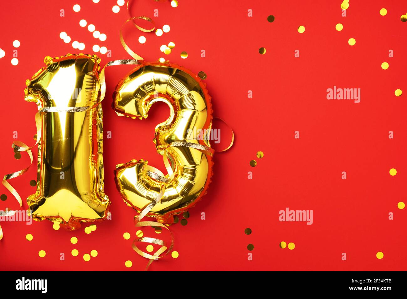 Gold foil balloon number, digit thirteen. Birthday greeting card ...