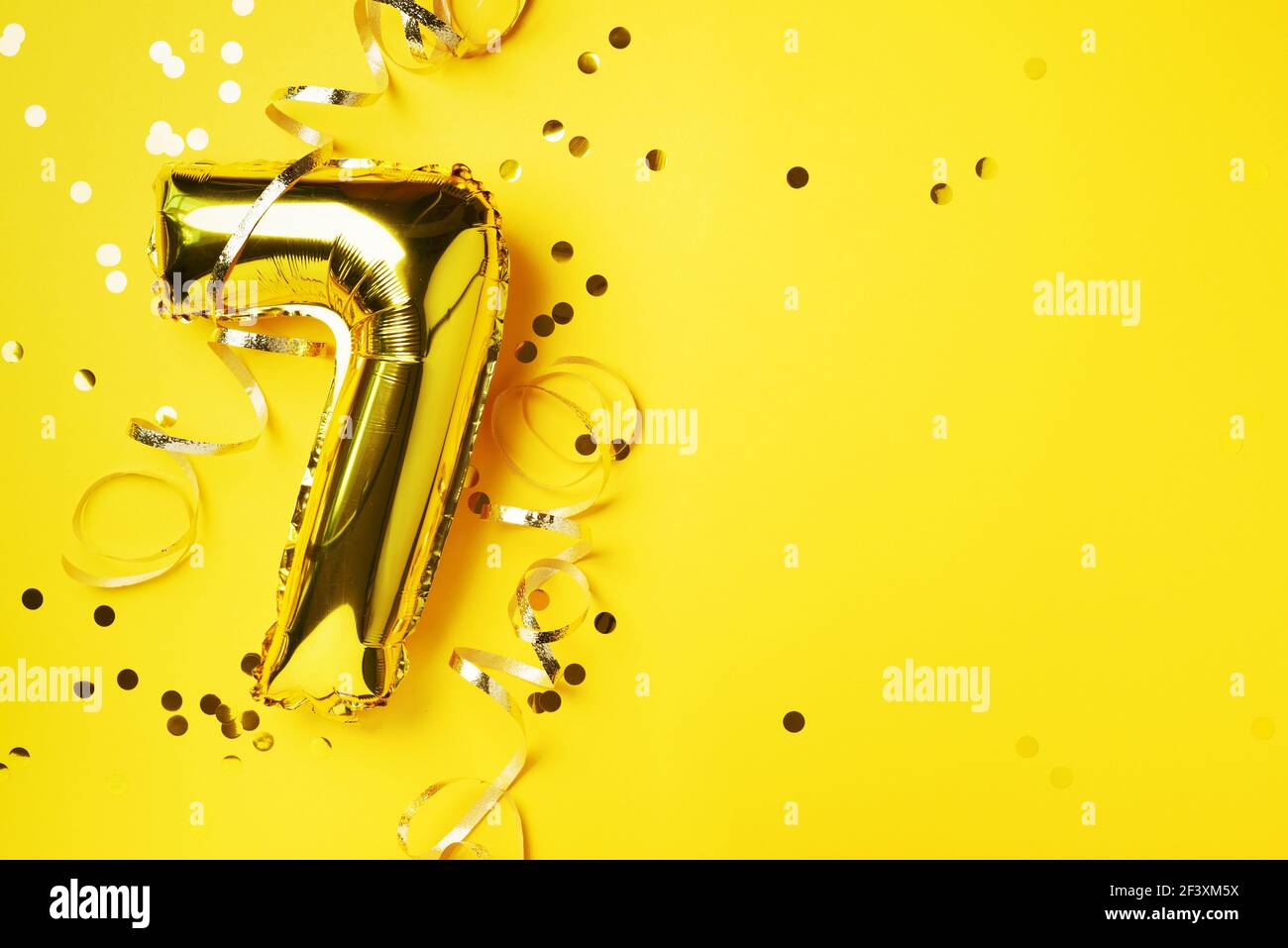 Gold foil balloon number and digit seven 7. Birthday greeting card ...