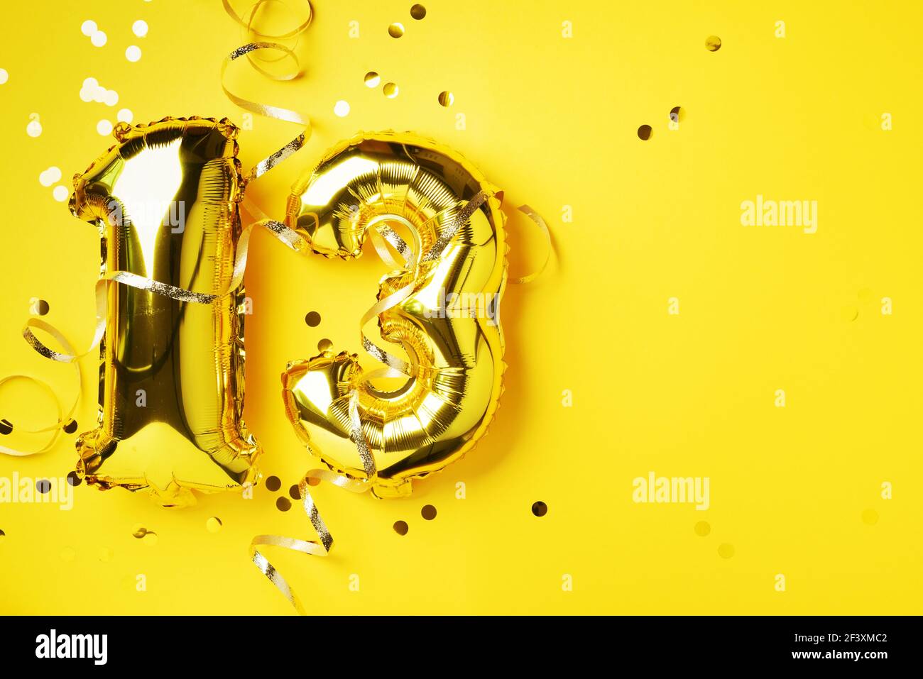 Gold foil balloon number, digit thirteen. Birthday greeting card ...