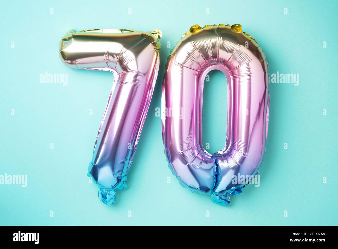 Rainbow foil balloon number, digit seventy. Birthday greeting card with ...