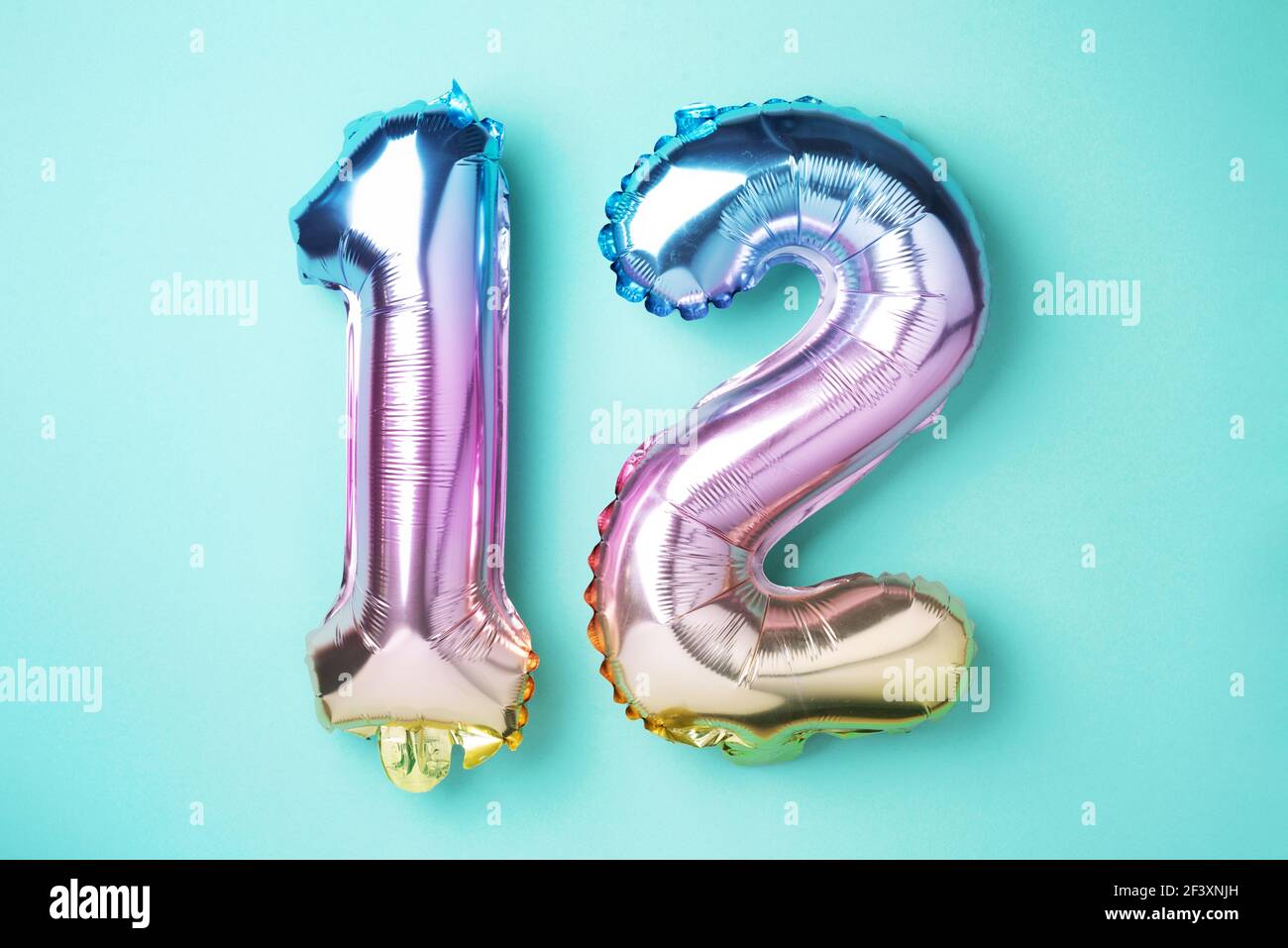 Creative layout. Rainbow foil balloon number, digit twelve. Birthday ...