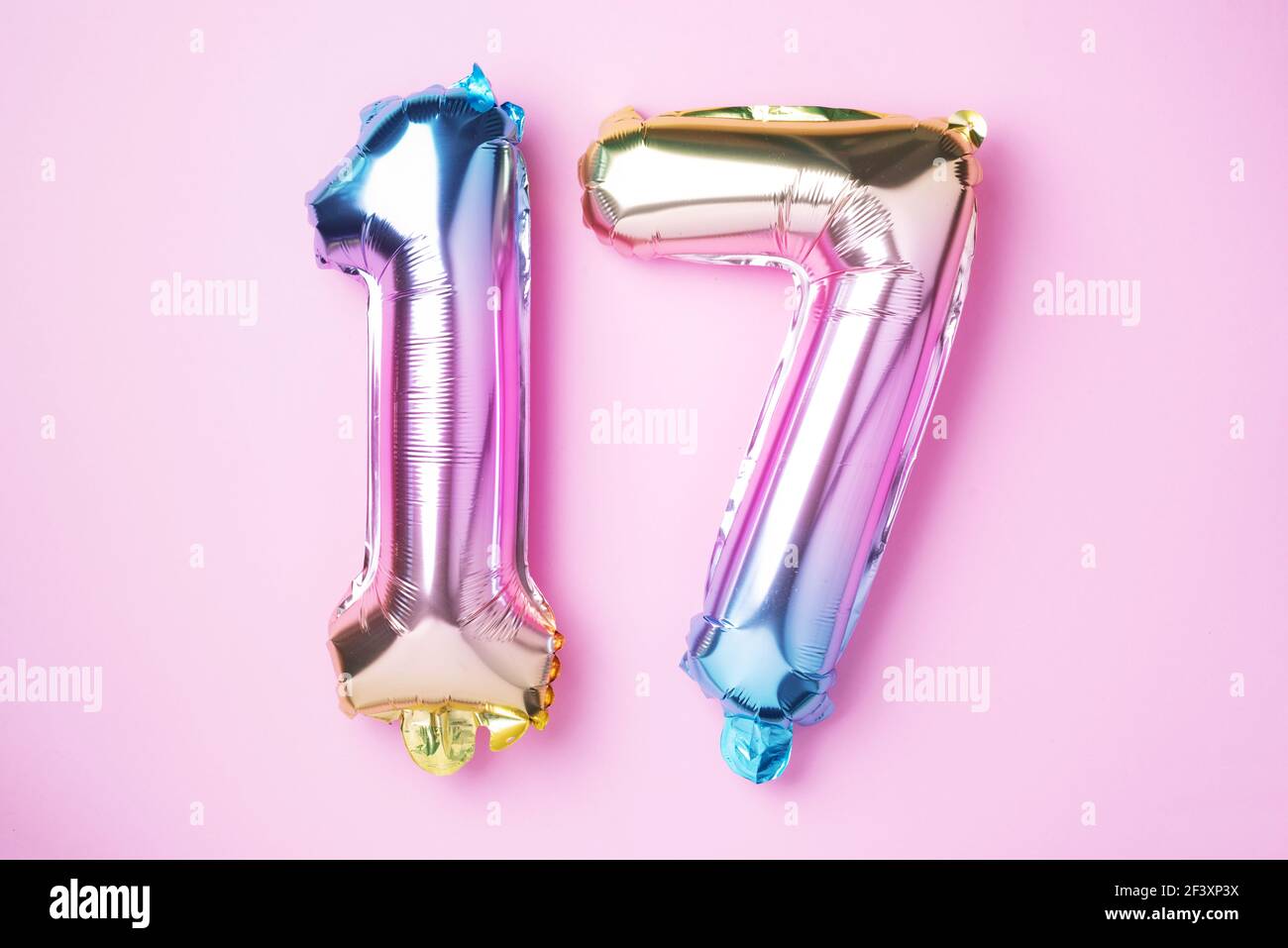 Creative layout. Rainbow foil balloon number, digit seventeen. Birthday ...