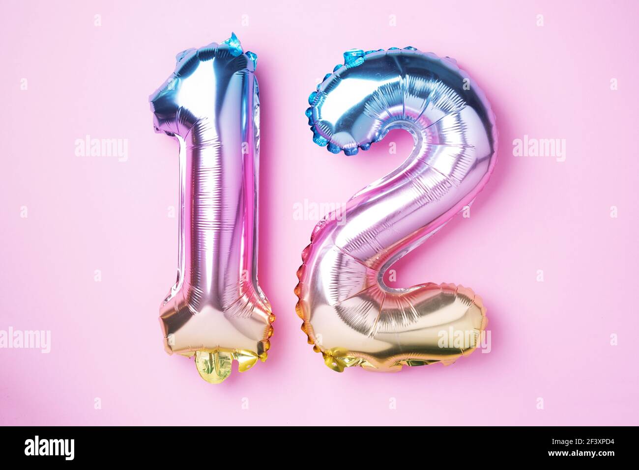 Creative layout. Rainbow foil balloon number, digit twelve. Birthday ...