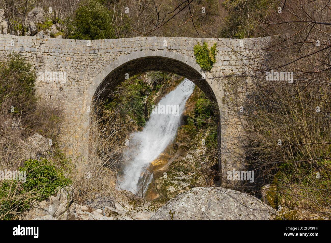 waterfall behind the bridge Stock Photo - Alamy