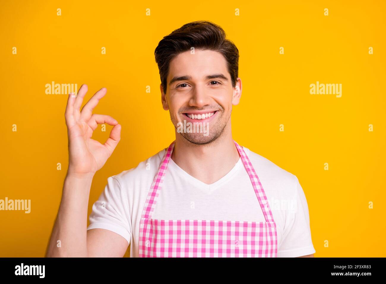 Photo portrait of guy showing ok-sign isolated on vivid yellow colored ...