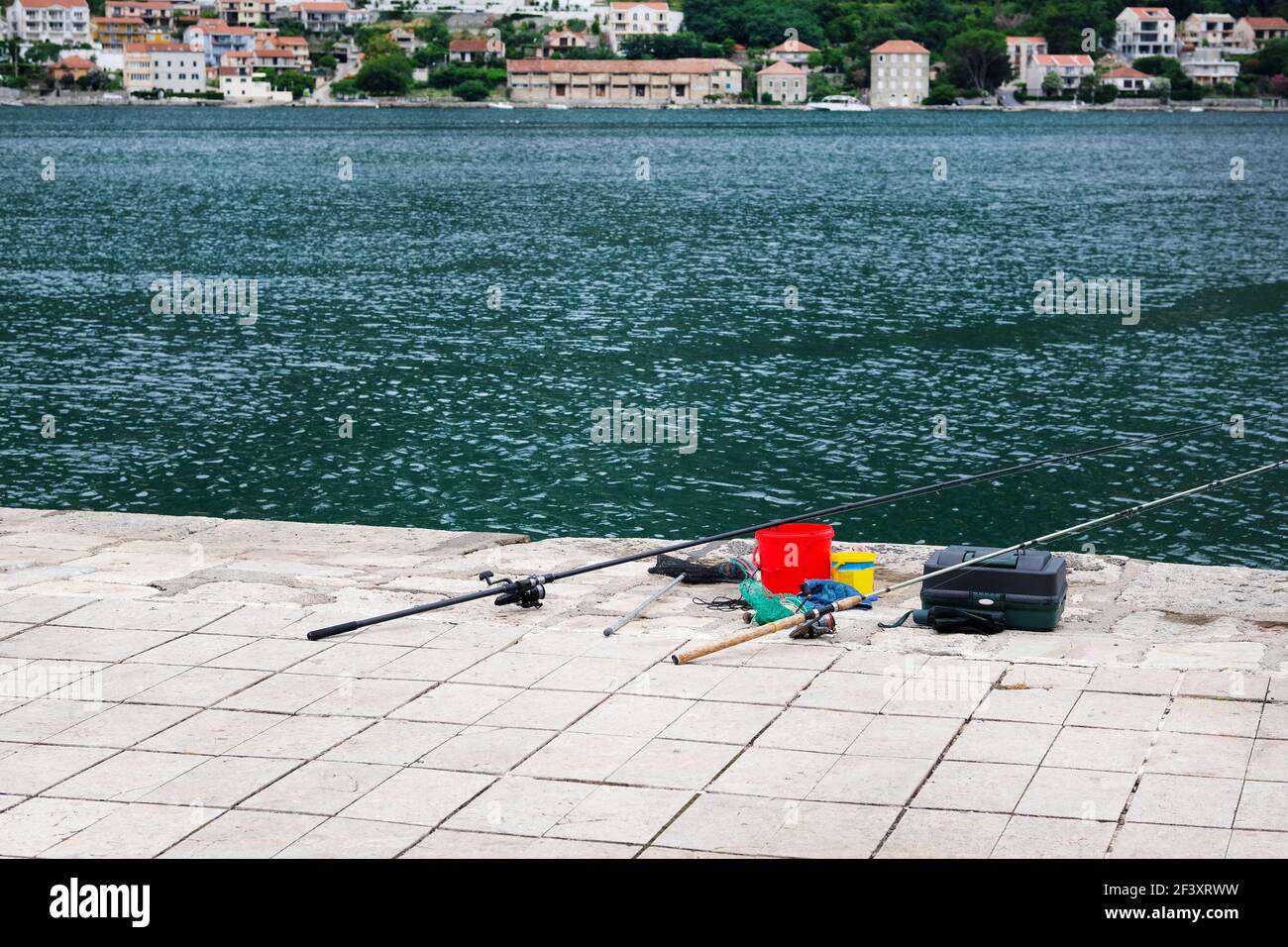 Fishing equipment on cement pier on seacoast. Picture of two commercial ...