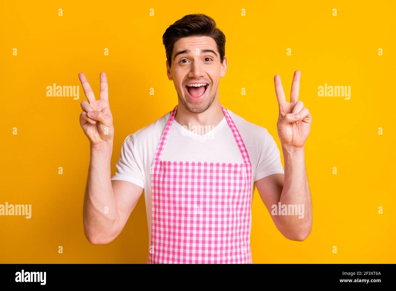 Photo portrait of cheerful man showing two v-signs isolated on vivid ...