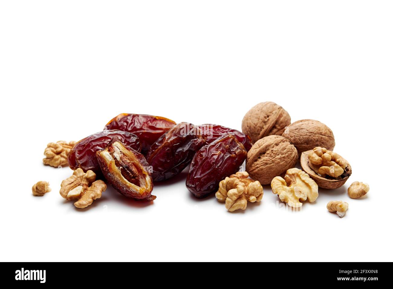 Dates fruit and walnuts on white background Stock Photo - Alamy