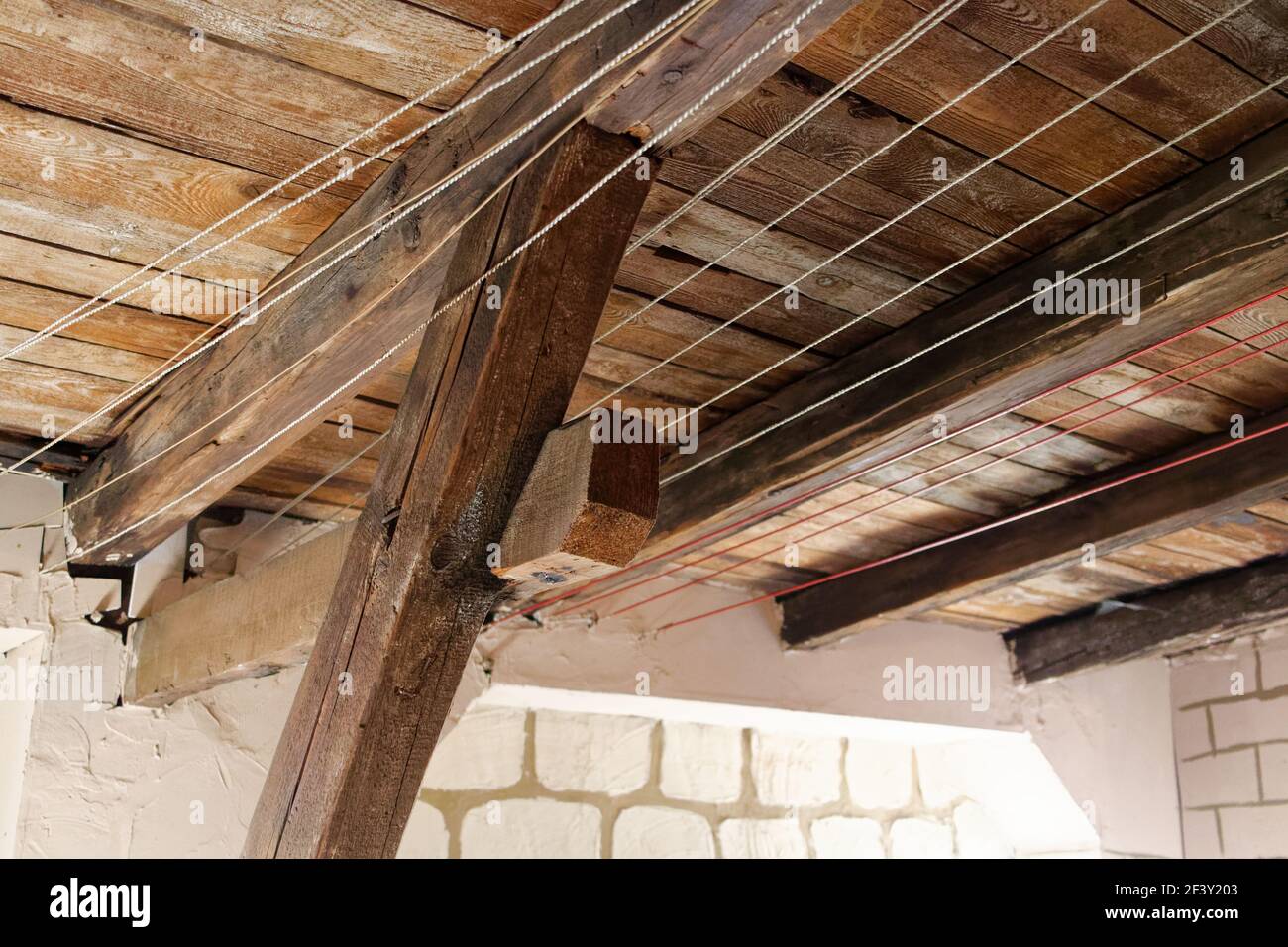 Attic of an old tenement house with wooden beams and planks of the roof ...