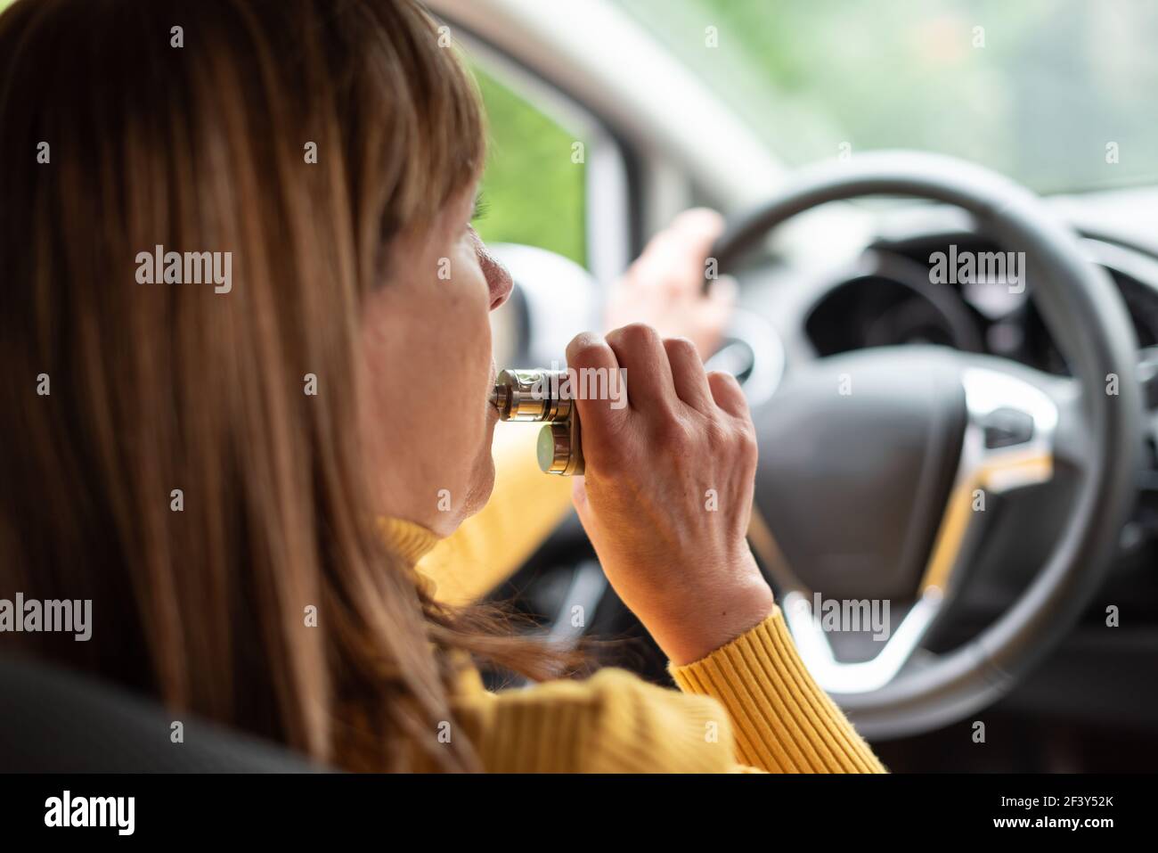 Woman smoking cigarette driving hi-res stock photography and images - Alamy