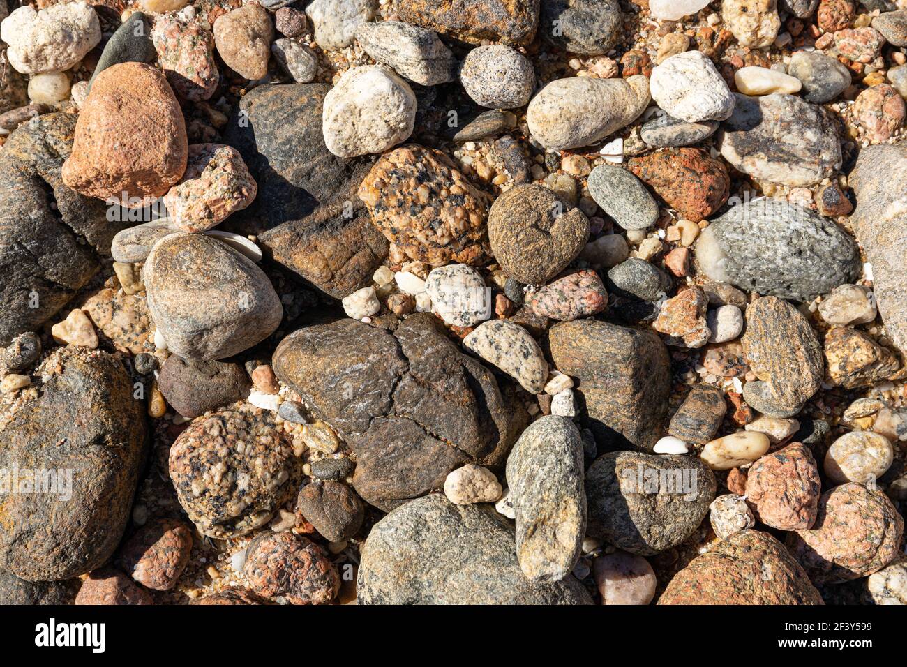 Dry round stones on beach abstract background Stock Photo - Alamy