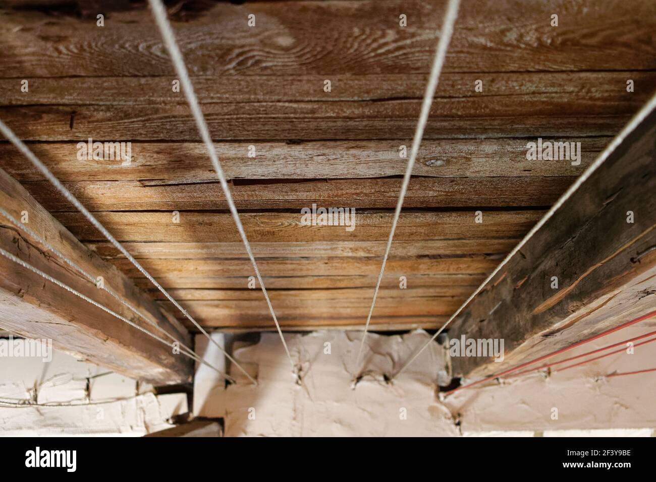 Attic of an old tenement house with wooden beams and planks of the roof ...