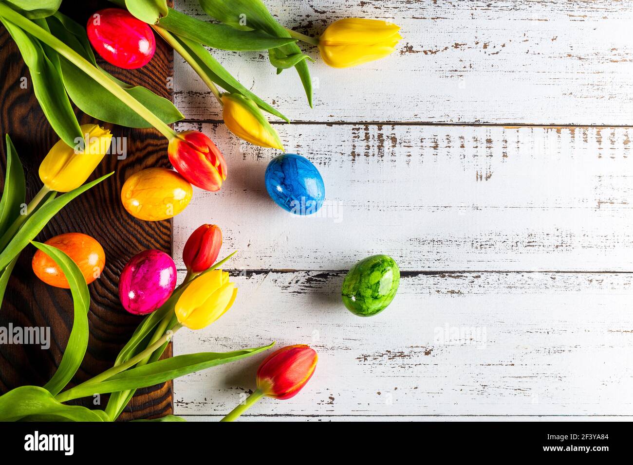 Easter wooden background with coloured eggs Stock Photo - Alamy
