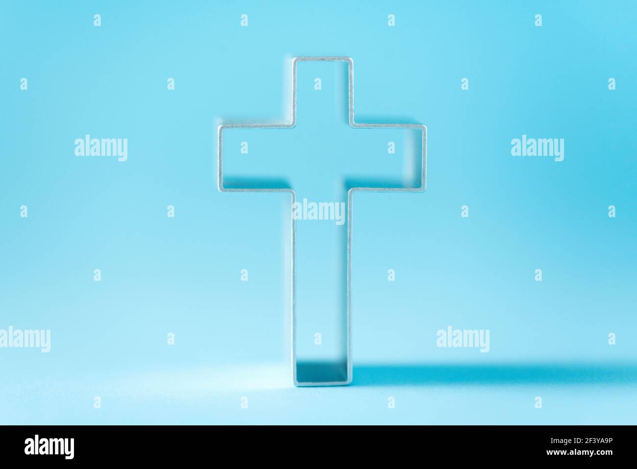 Christian cross on blue background with soft bokeh lights background ...