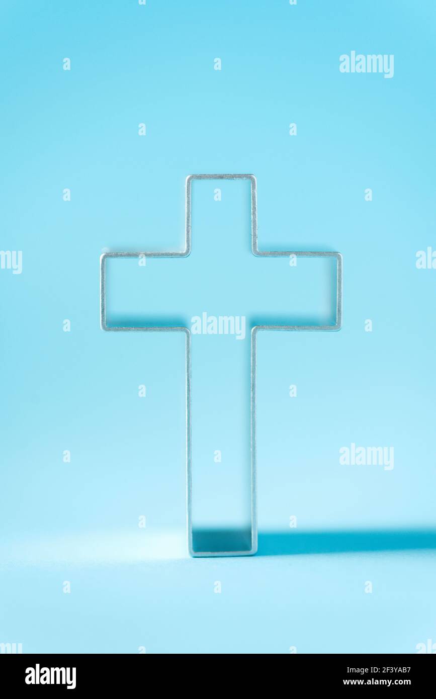 Christian cross on blue background with soft bokeh lights background ...