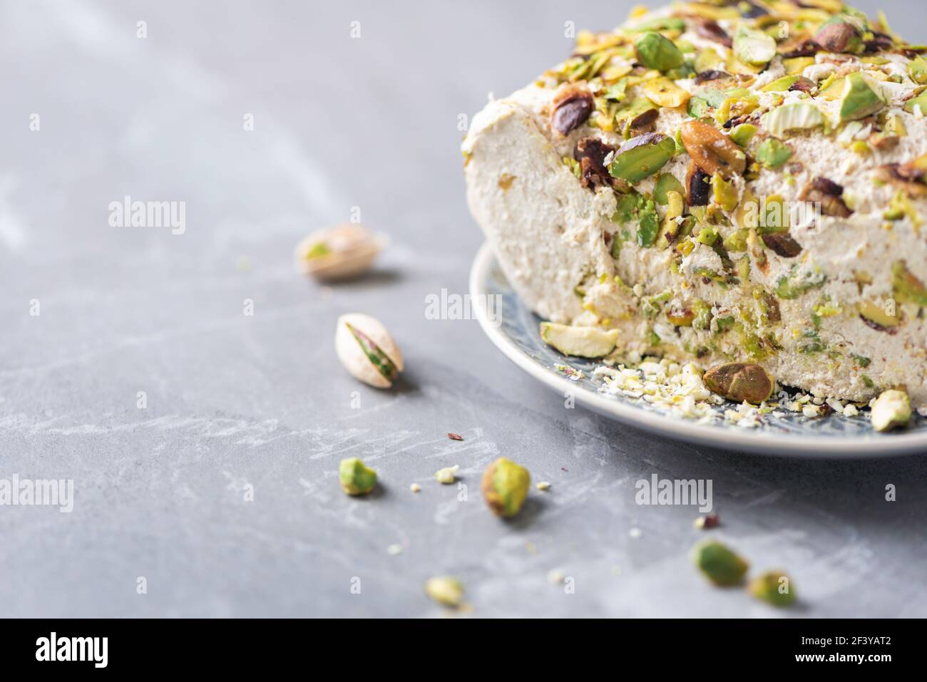 Sesame halva with pistachios on grey background. Top view. Copy space ...