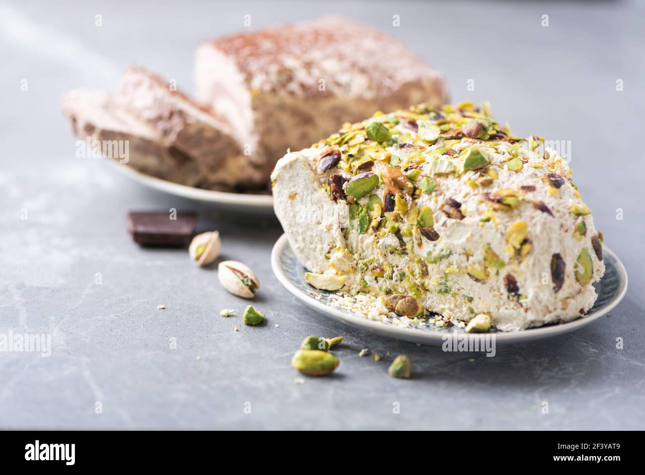 Sesame chocolate halva and halva with pistachios on grey background ...