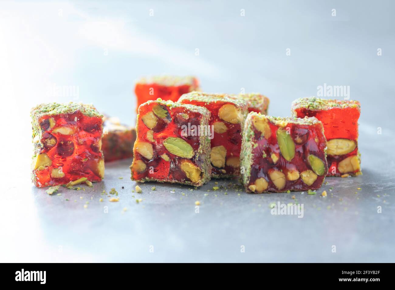 Turkish delight - lokum or rahat lokum with pistachios on grey ...