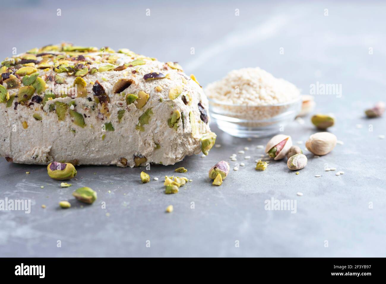 Sesame halva with pistachios on grey background. Top view. Copy space ...