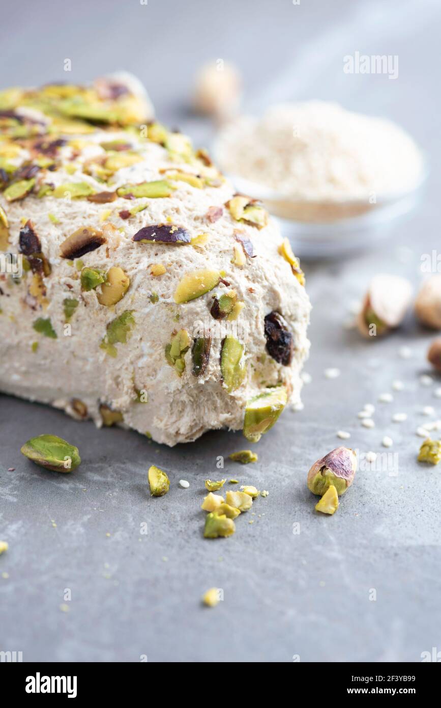 Sesame halva with pistachios on grey background. Top view. Copy space ...