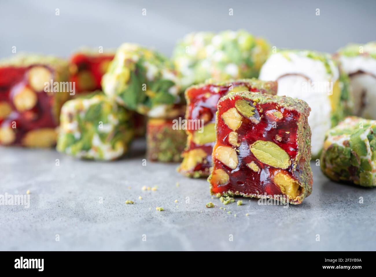 Turkish delight - lokum or rahat lokum with pistachios on grey ...
