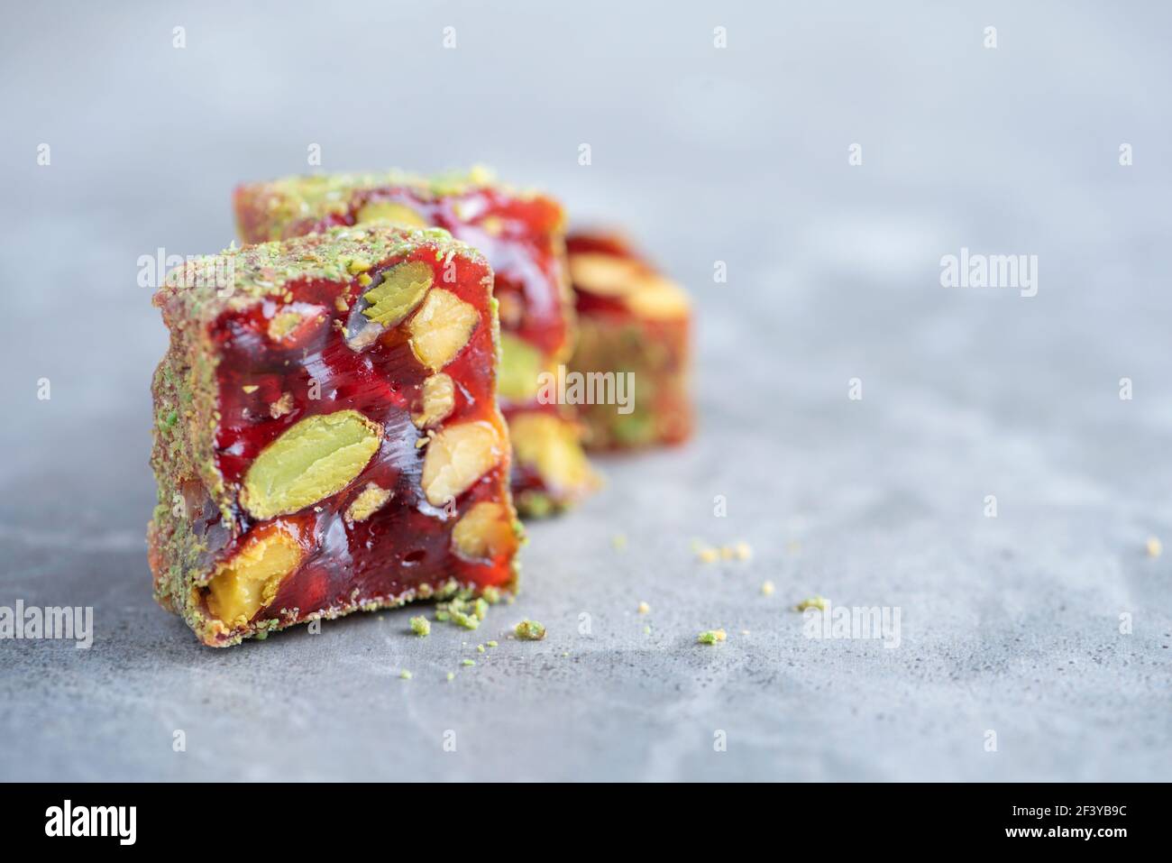 Turkish delight with pistachios on grey background. Copy space ...
