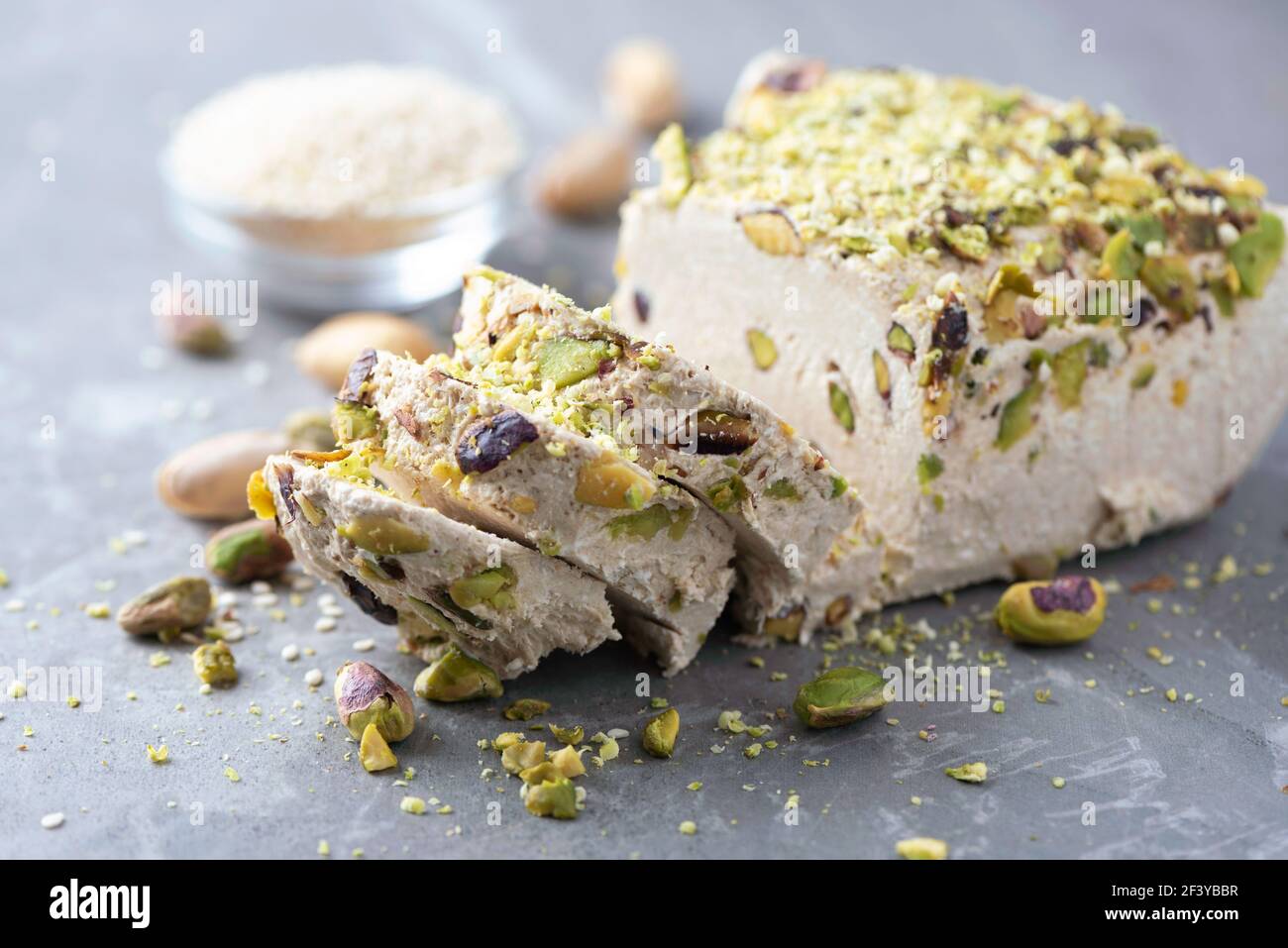 Sesame halva with pistachios on grey background. Top view. Copy space ...