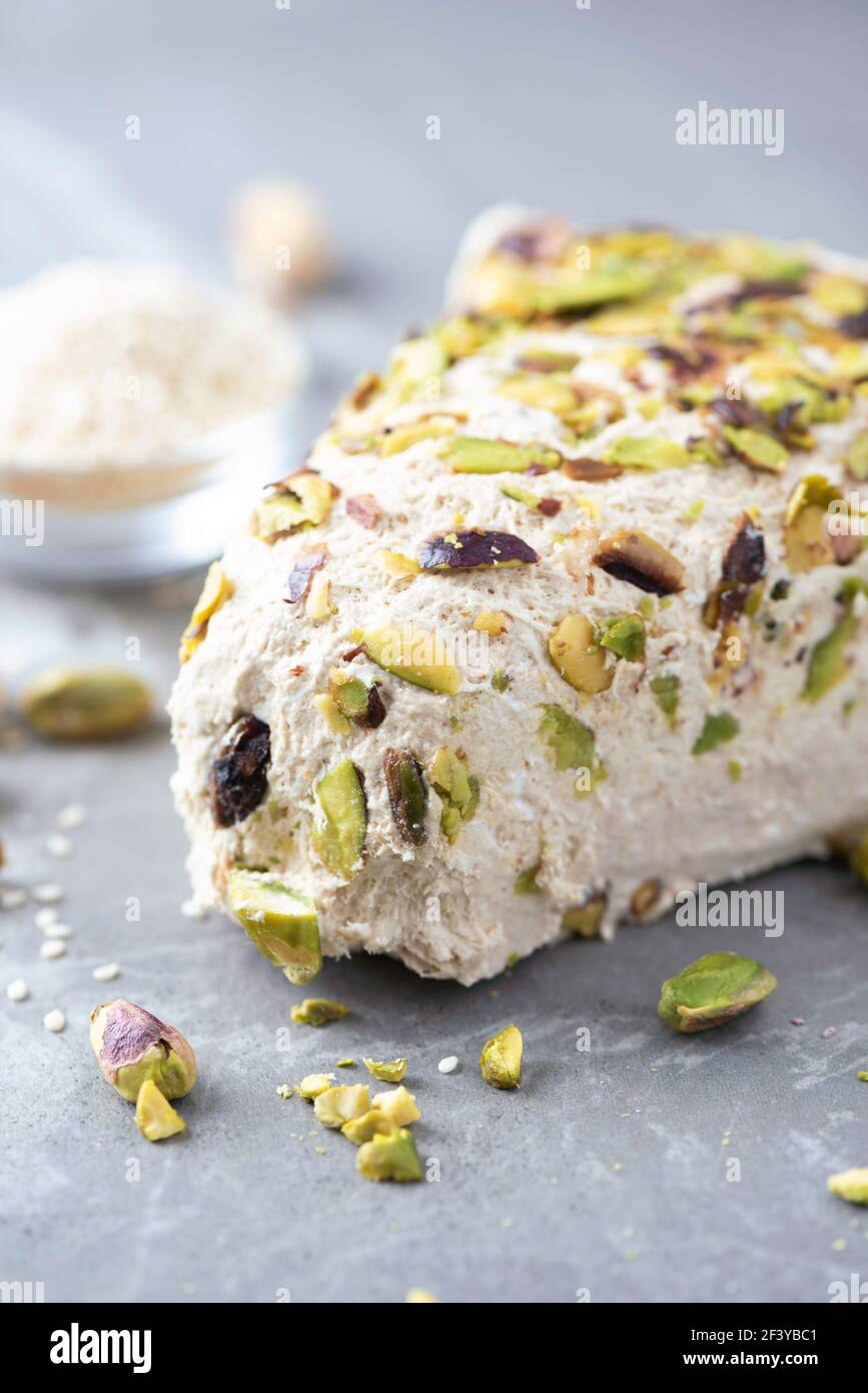 Sesame halva with pistachios on grey background. Top view. Copy space ...