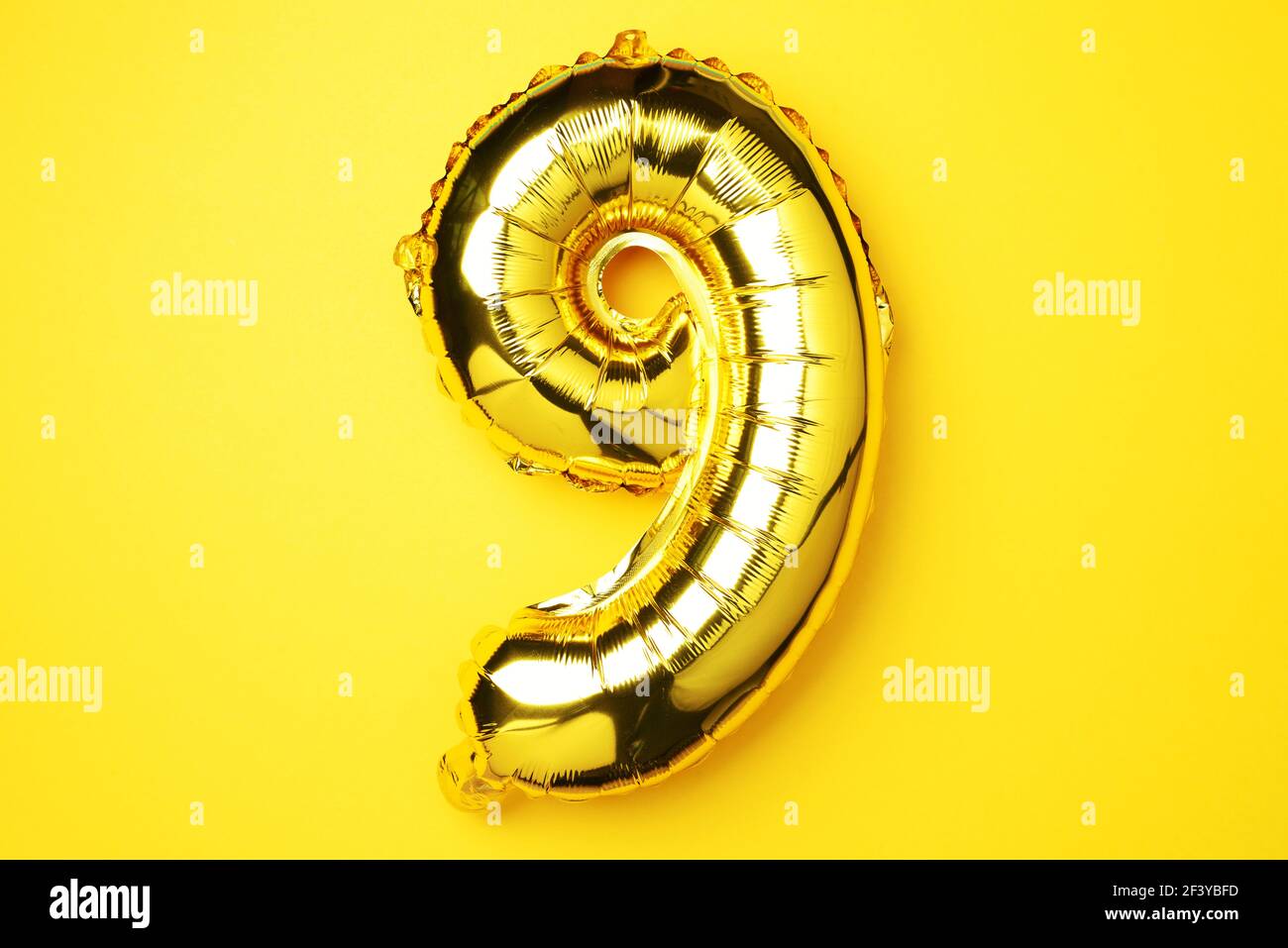 Creative layout. Golden foil balloon number and digit nine 9. Birthday ...